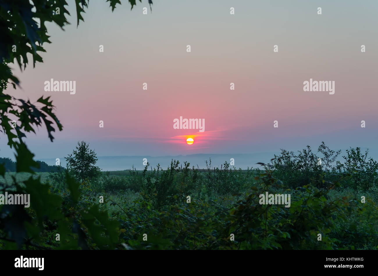 Sun rising over misty mountains hi-res stock photography and images - Alamy