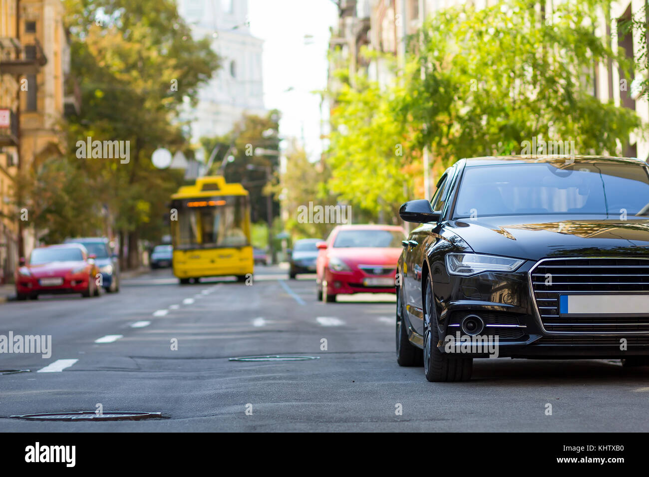 Modern new car on the side of the street. Rows of cars parked on the ...