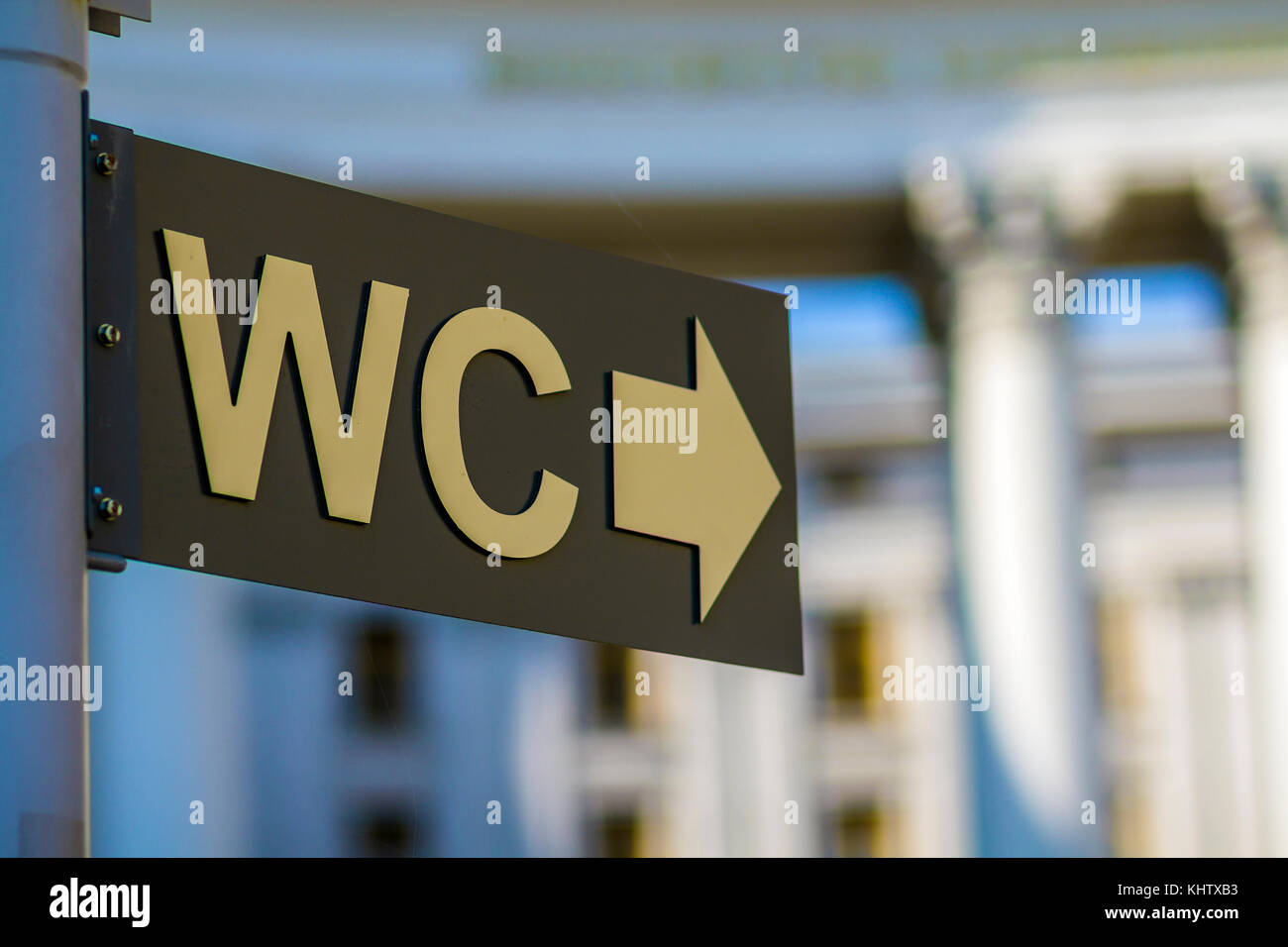 Toilet sign and direction outdoors- public restroom concept on urban ...