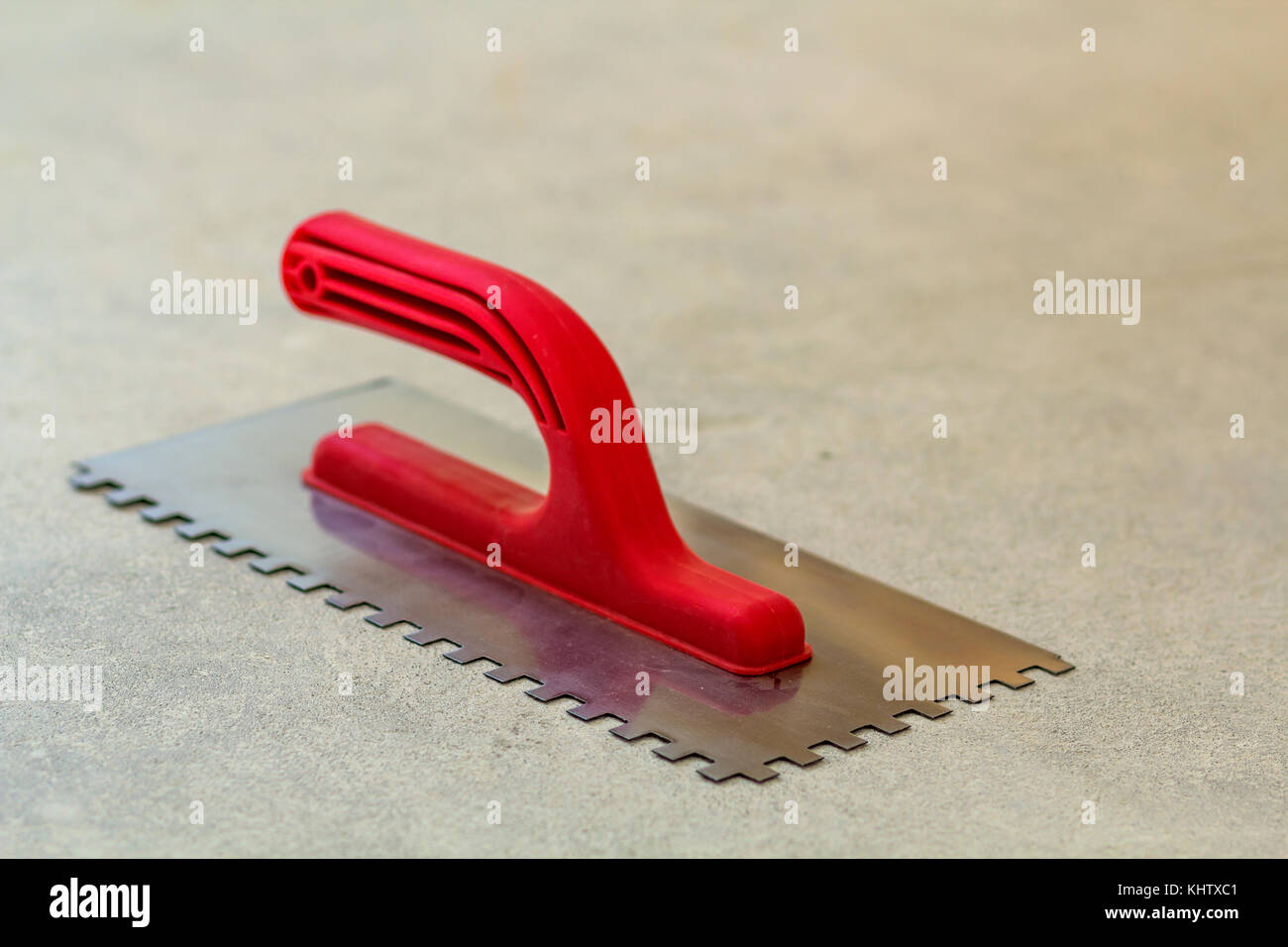 Construction notched trowel is a tool for tiles installation work Stock ...