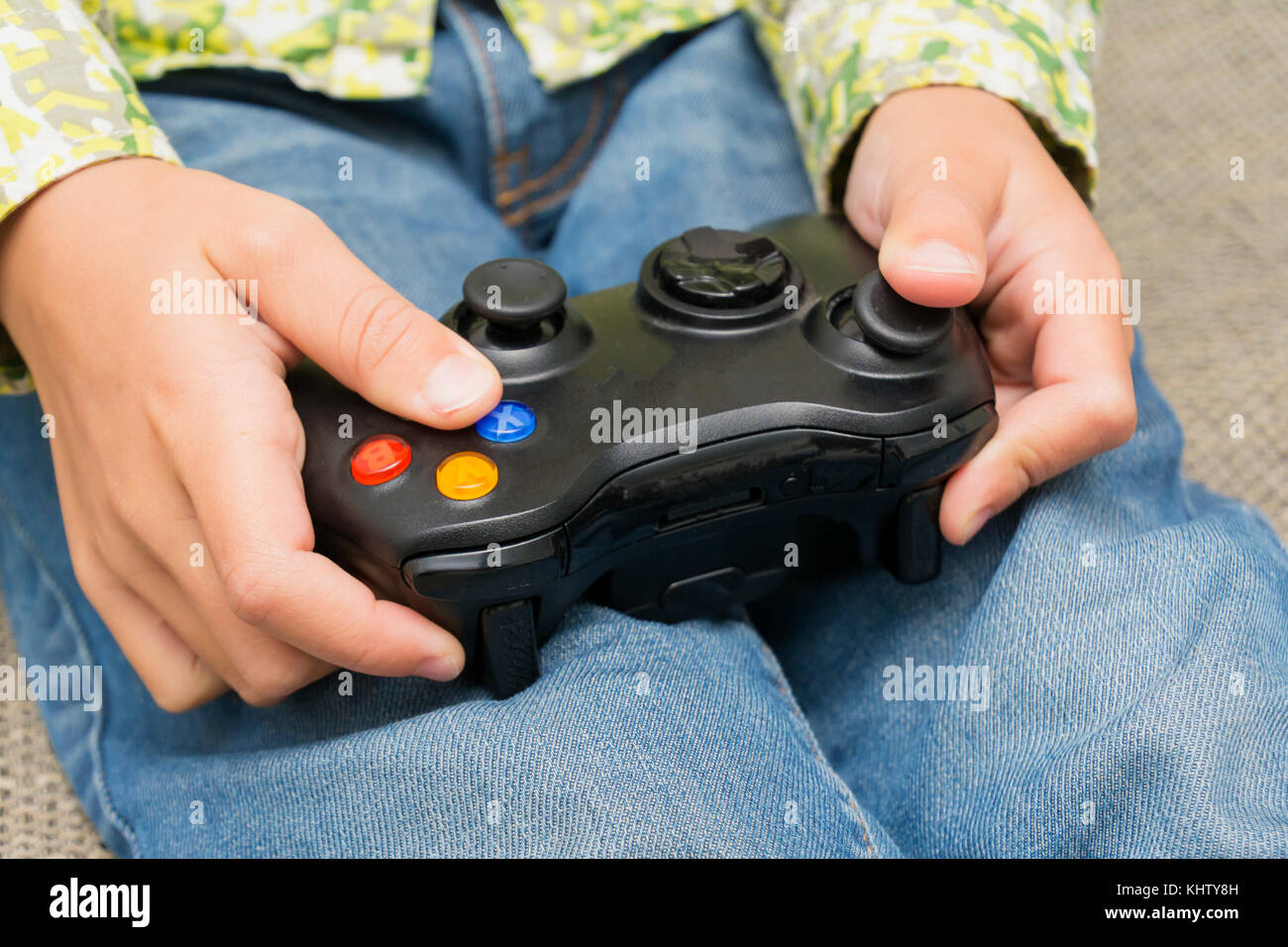 Hands Holding a Joystick Controller while playing a video games at home ...