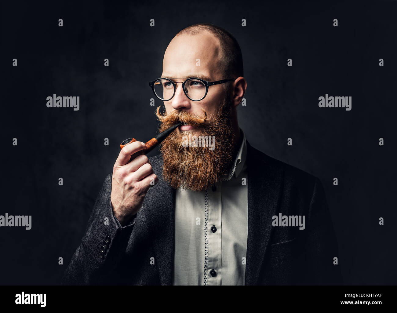 A man smoking pipe over grey background Stock Photo - Alamy