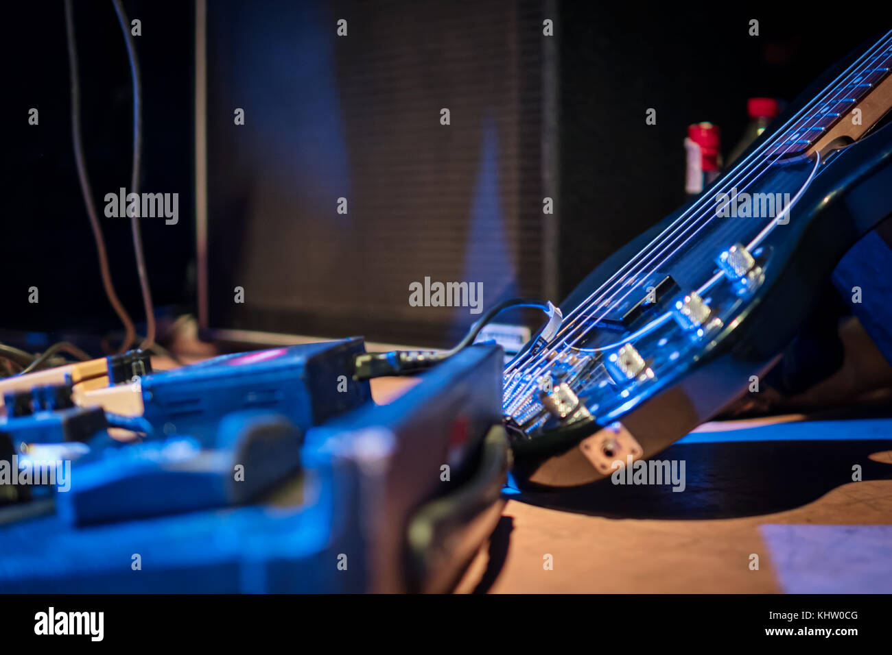 Bass guitar connected to electricity in a blue concert light Stock ...