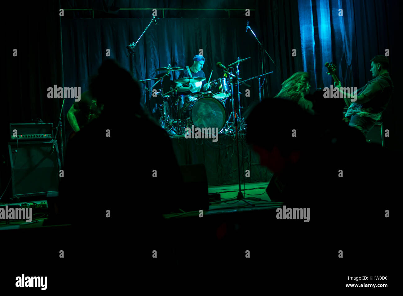 Blue light illuminates a drummer at a rock band concert Stock Photo - Alamy