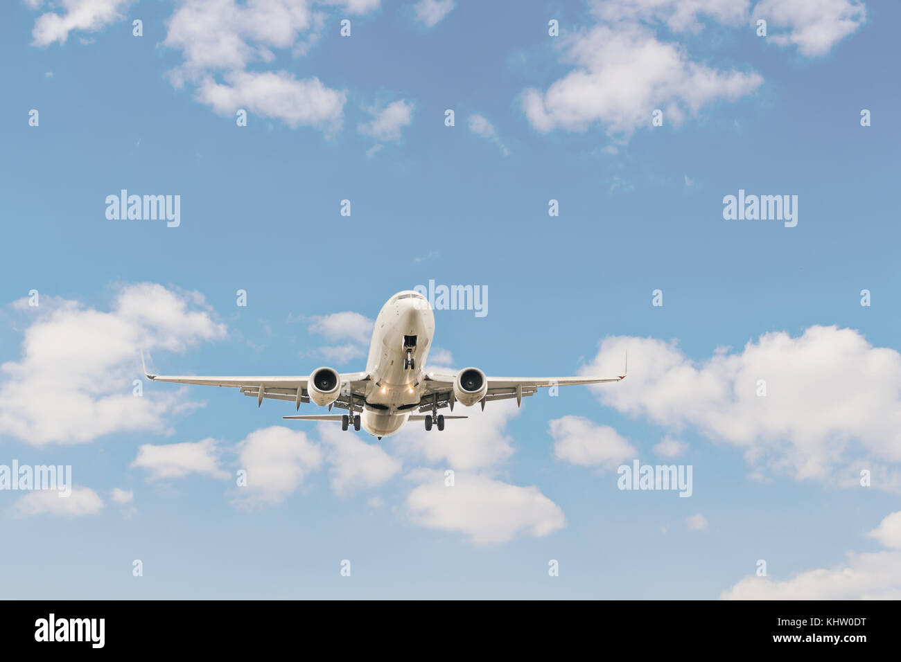 Flying at the camera airplane close-up with a released chassis against ...