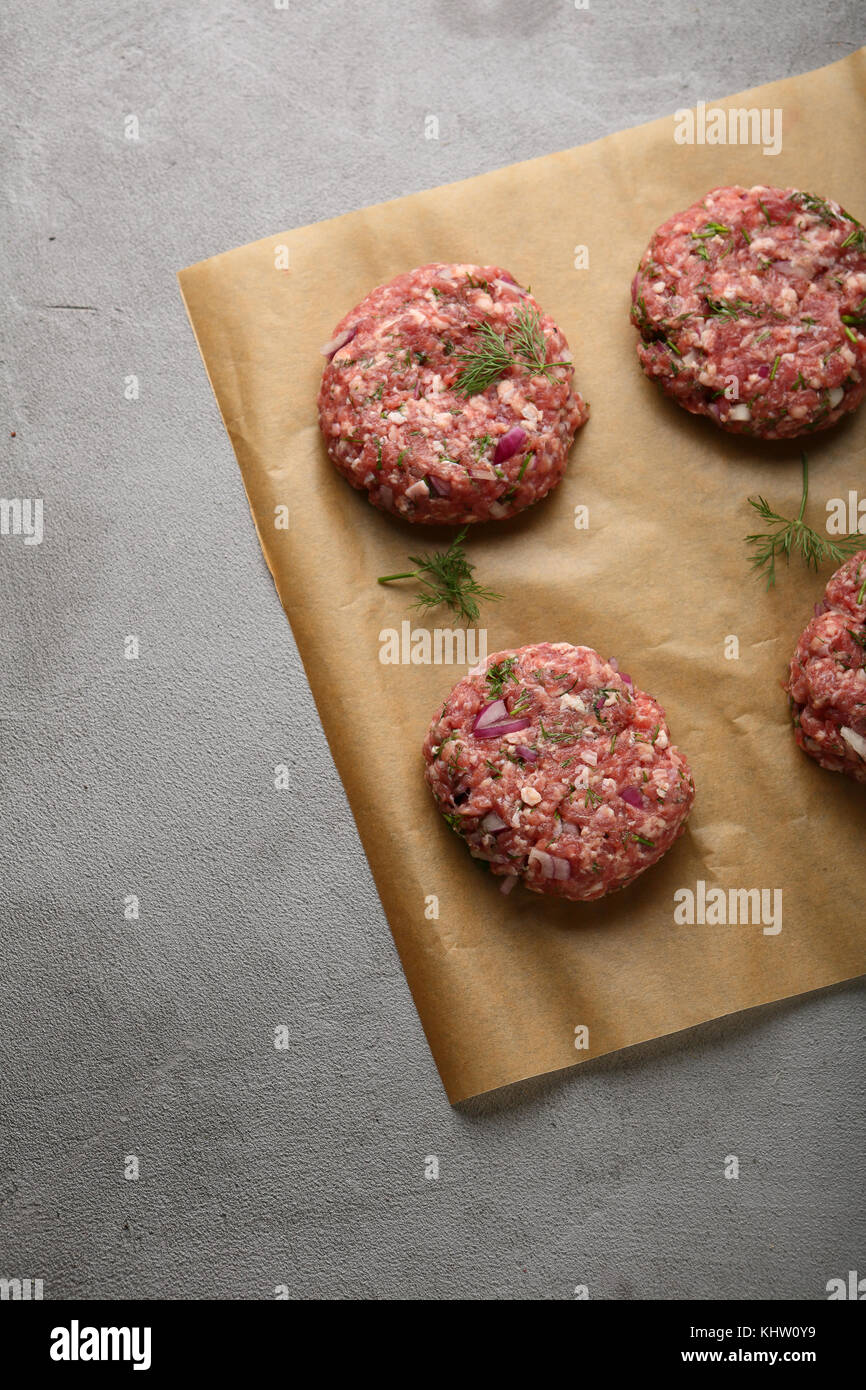 minced beef steak burgers on gray background, raw Stock Photo - Alamy