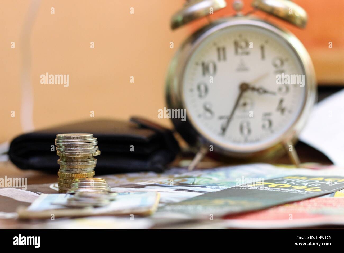alarm clock and ready-made money wallet in the background Stock Photo ...