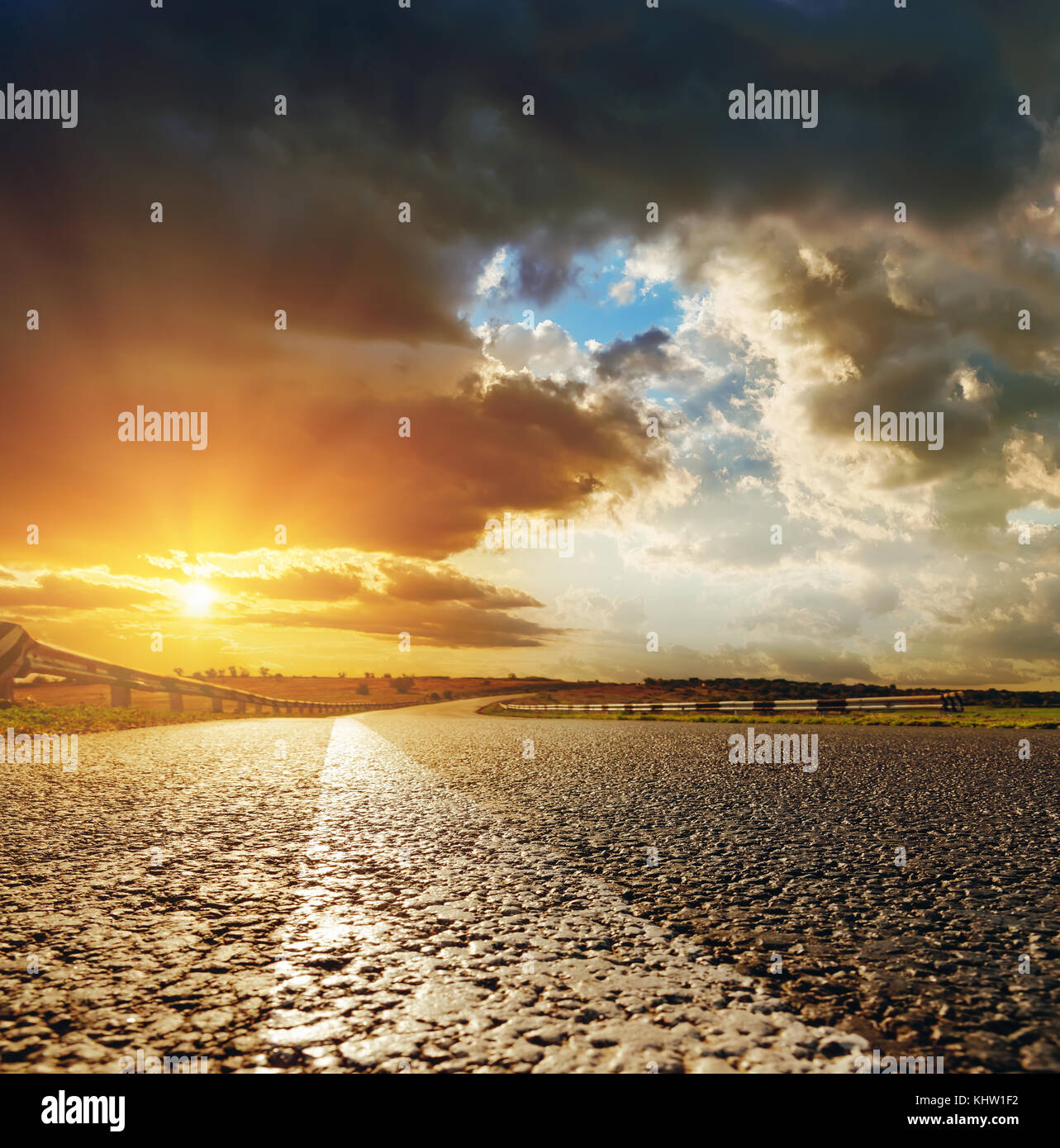 low sunset in dramatic sky over asphalt road Stock Photo - Alamy
