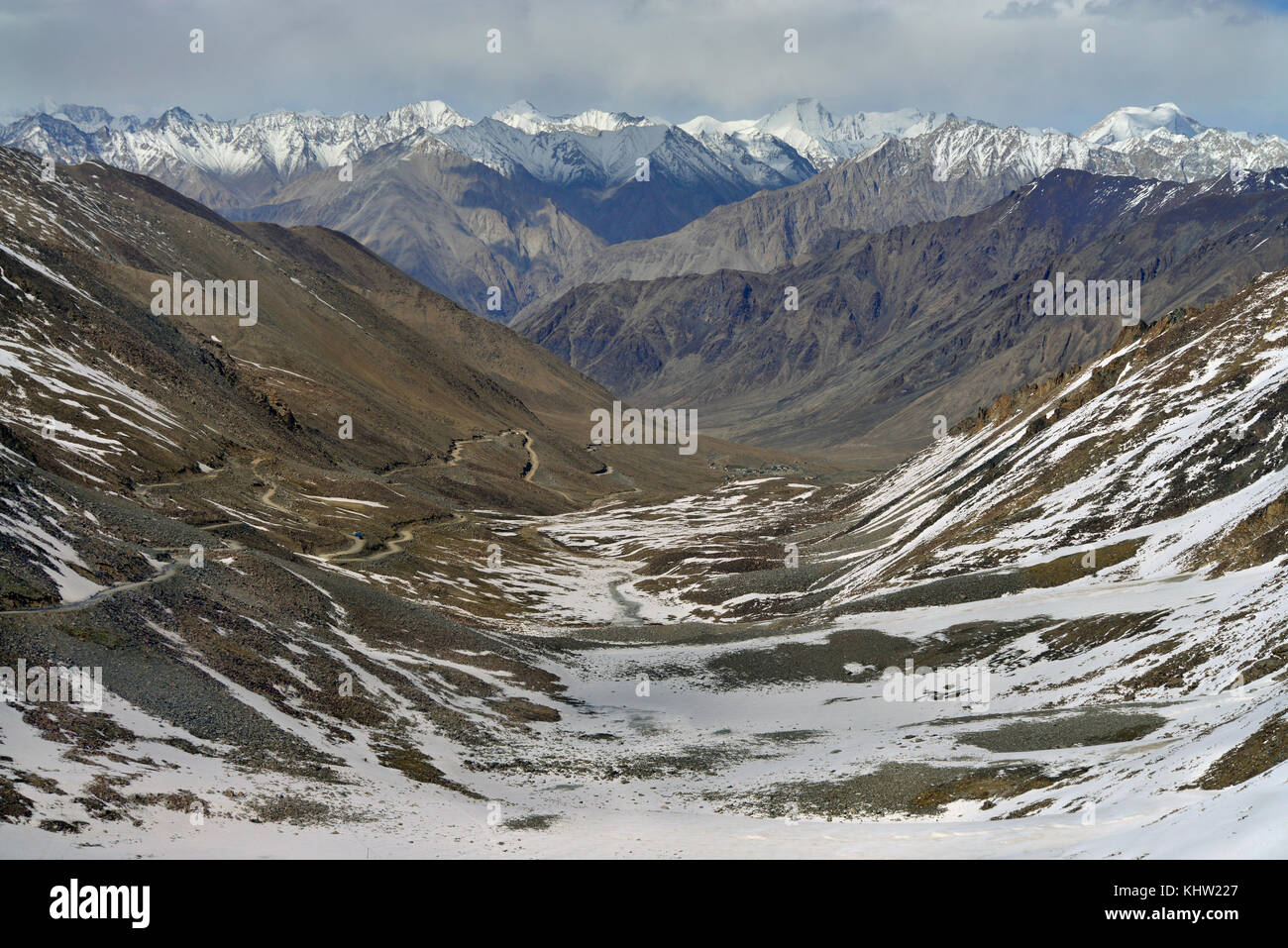The mountain valley, the slopes are covered with snow, along the left ...