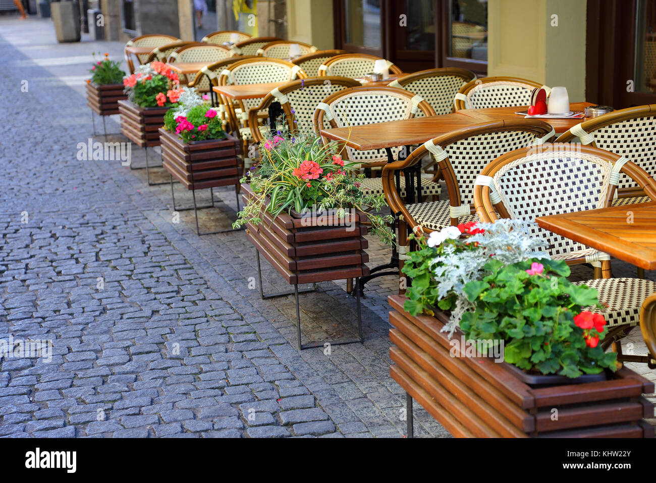 tables and chairs in a restaurant on the street Stock Photo - Alamy