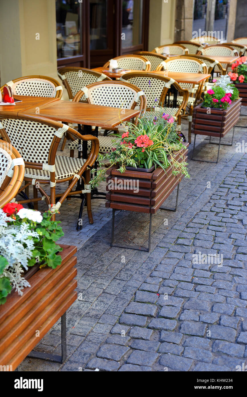 tables and chairs in a restaurant on the street Stock Photo - Alamy