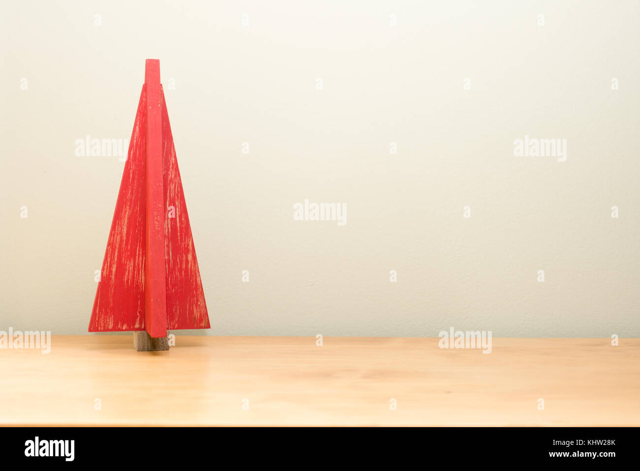 A stylized wooden red Christmas tree with distressed finish sitting on ...