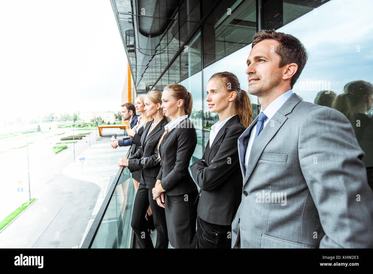 Business people team standing in a row at the balcony of modern office ...