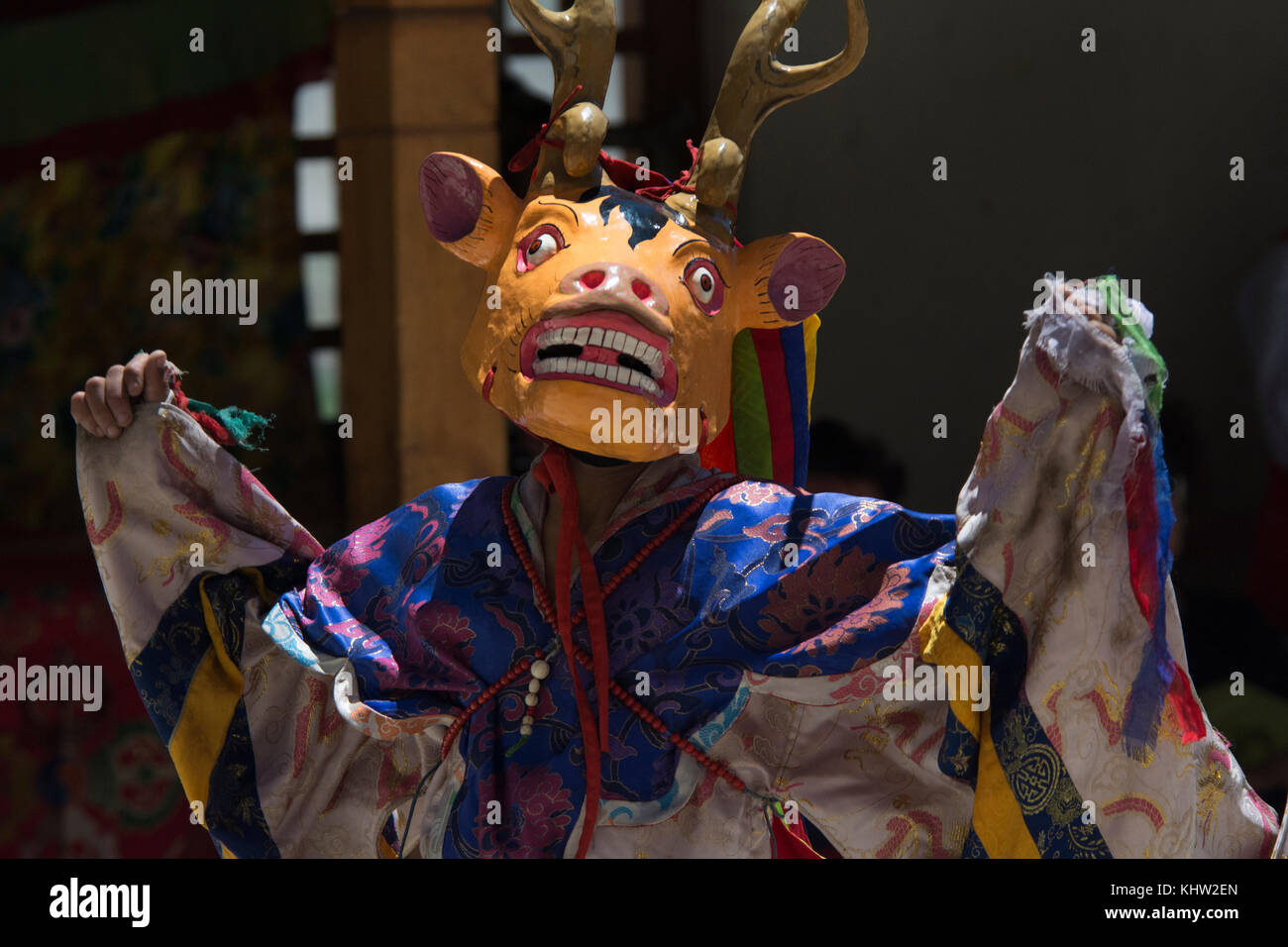 Tibetan monk in the Tantric Deer Mask and ritual attire against the ...