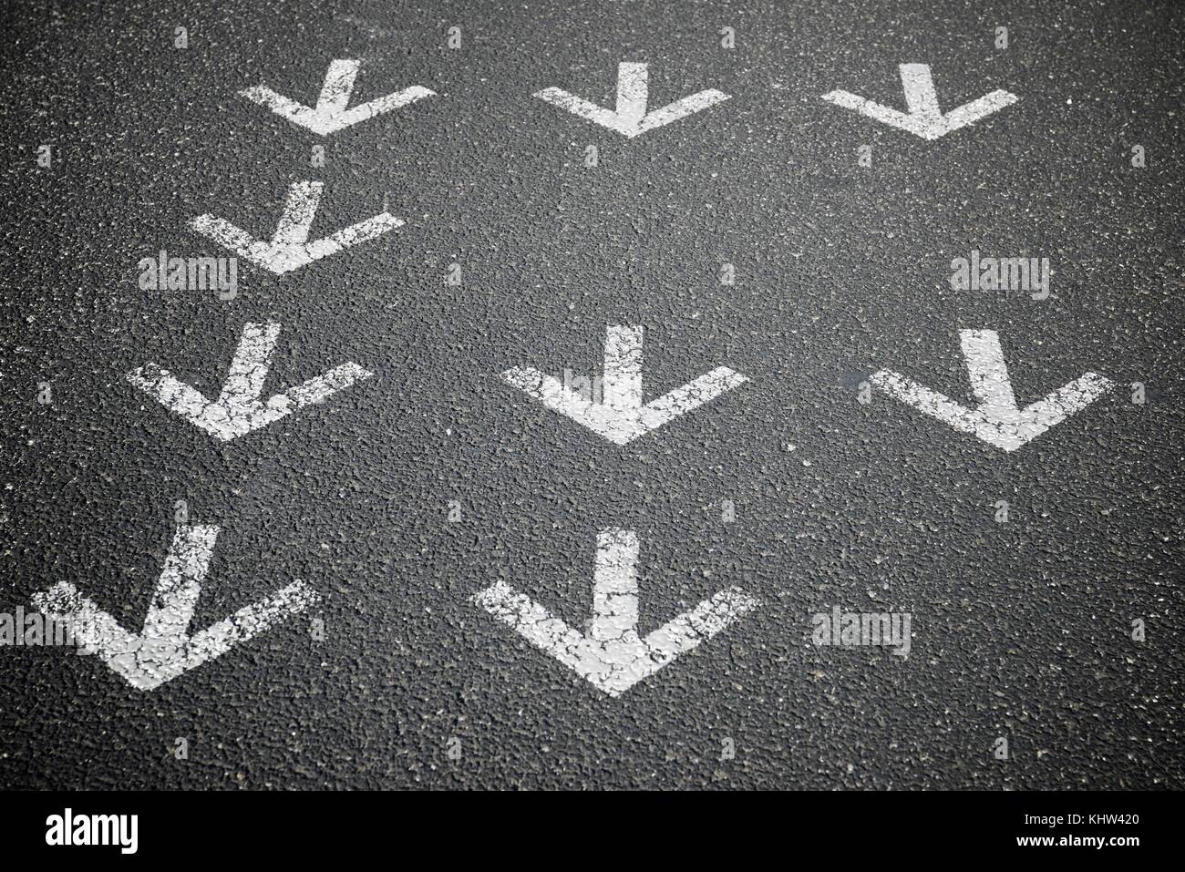 Directional arrows painted on a cement floor Stock Photo - Alamy