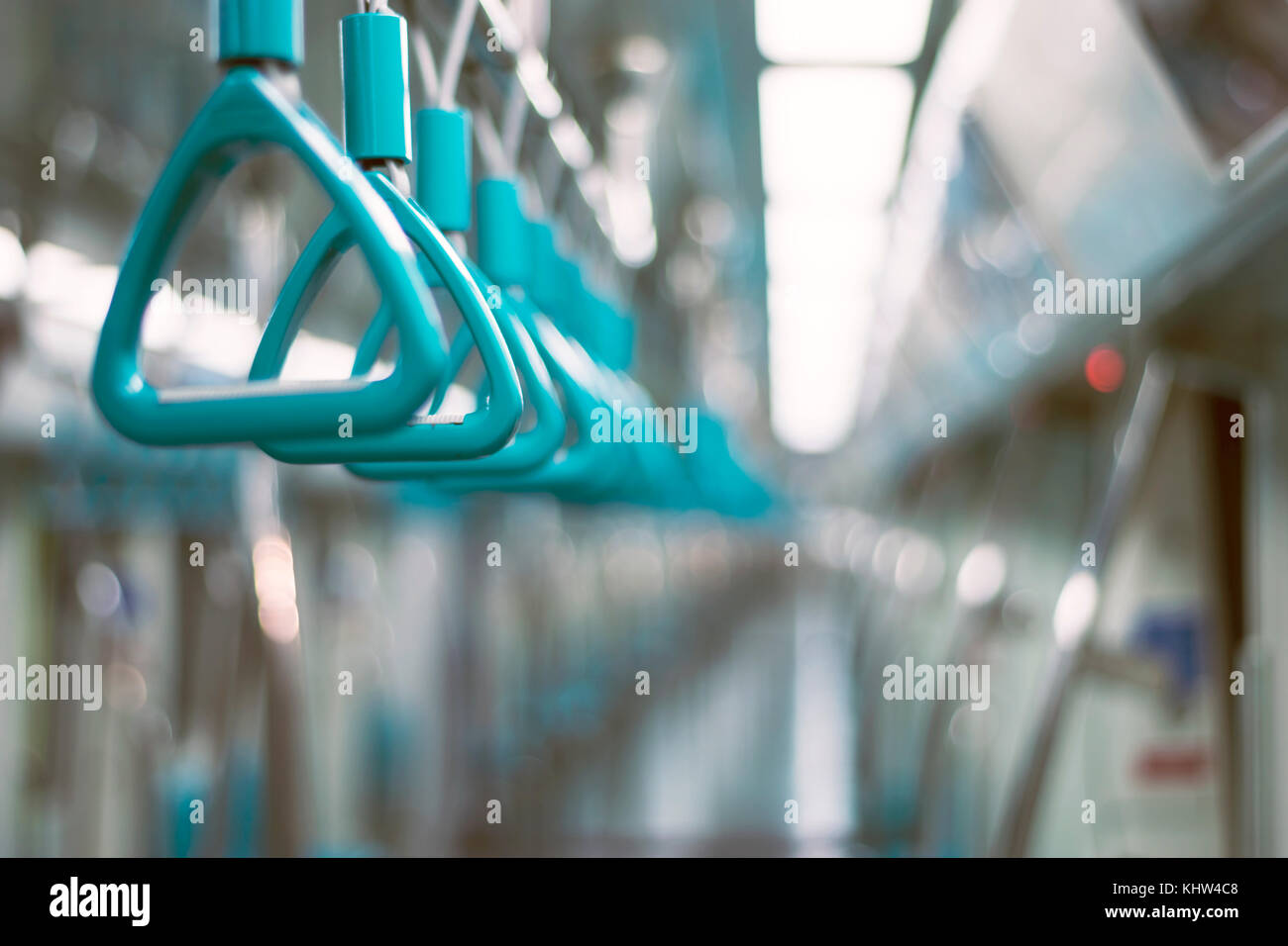 Triangles hanging on handrail inside metro carriage Stock Photo - Alamy