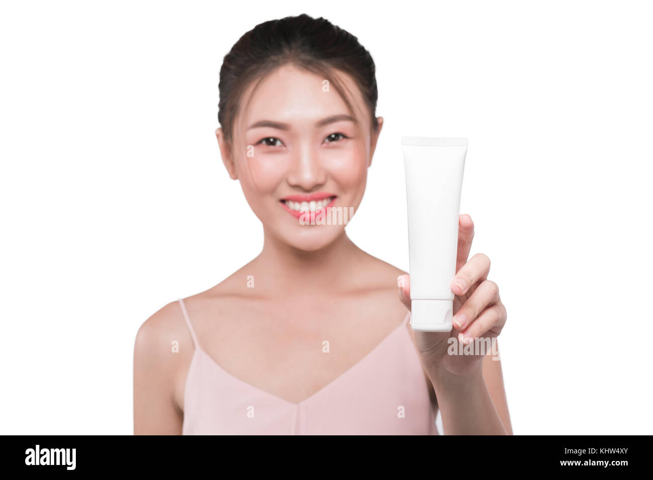 Beautiful model showing applying cosmetic cream treatment on her face ...