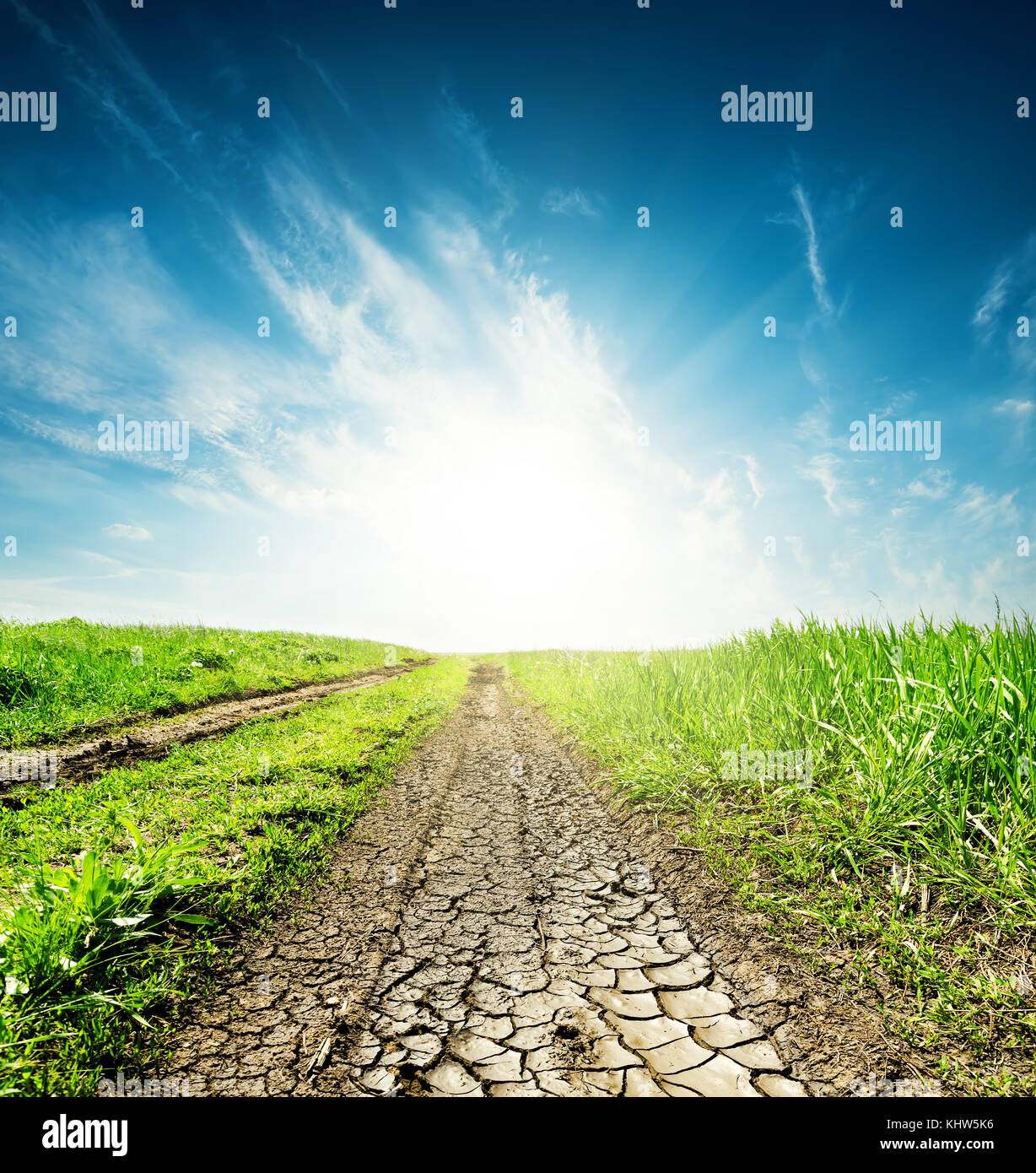 sunset in blue sky over drought earth Stock Photo - Alamy