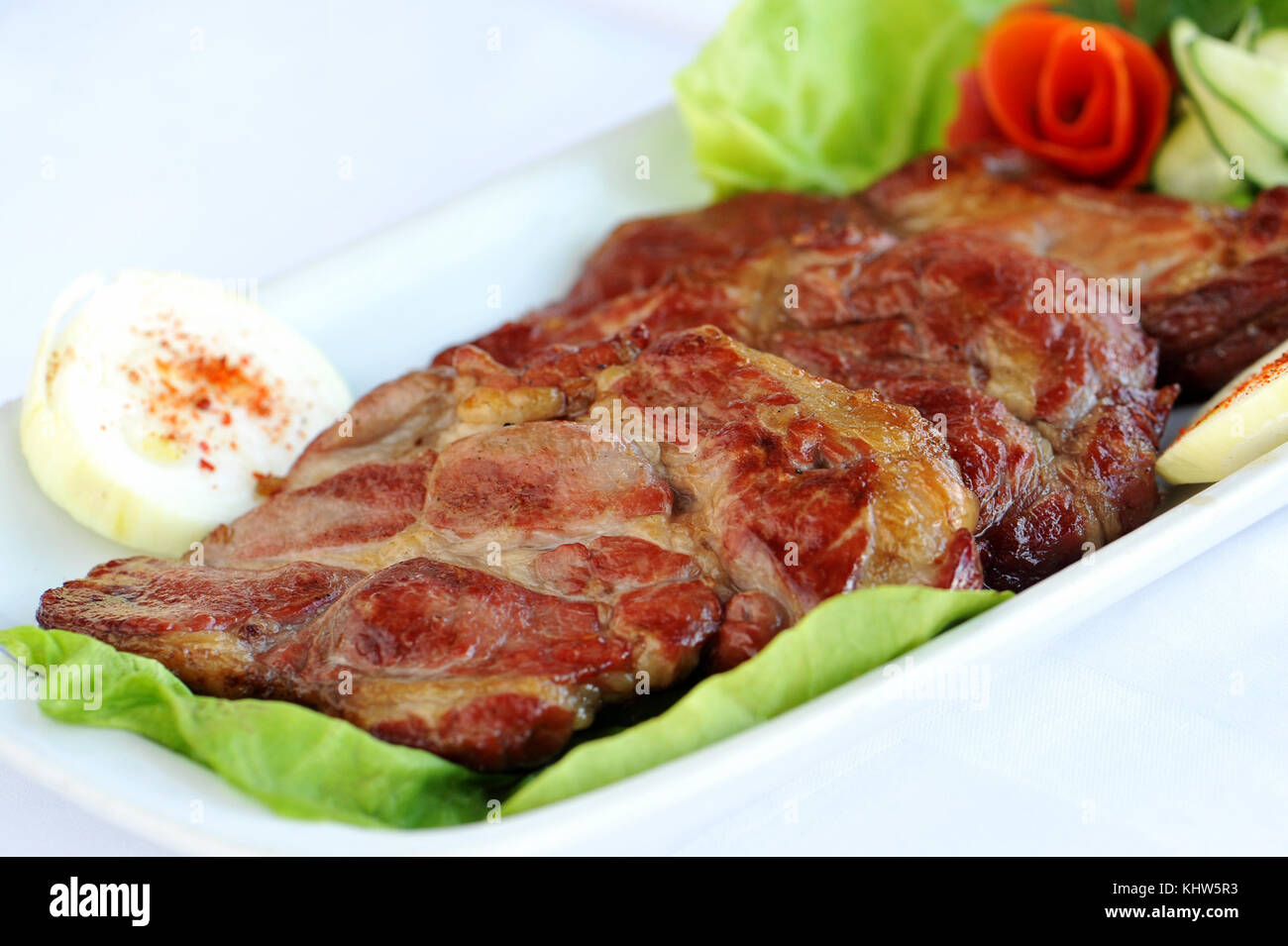 Grilled pork neck on a plate Stock Photo - Alamy