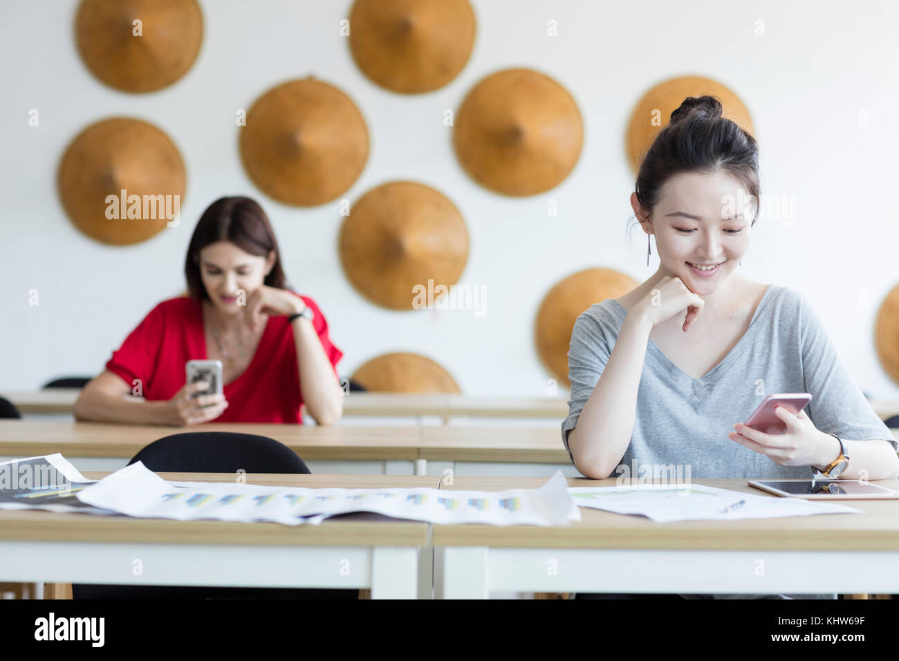 Students using mobile phone while waiting in class Stock Photo - Alamy