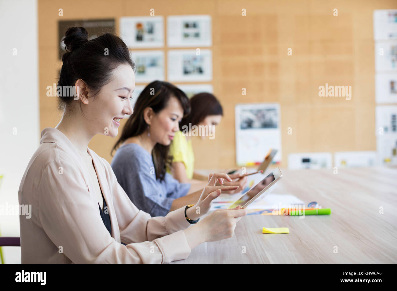 Students sitting and working side by side Stock Photo - Alamy