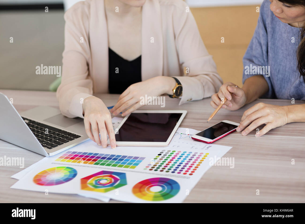 Colleagues working with colour charts and graphs Stock Photo - Alamy