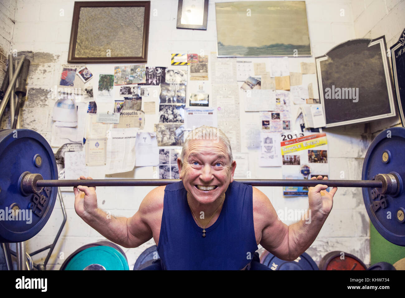 Senior male powerlifter lifting barbell on shoulders in gym Stock Photo ...