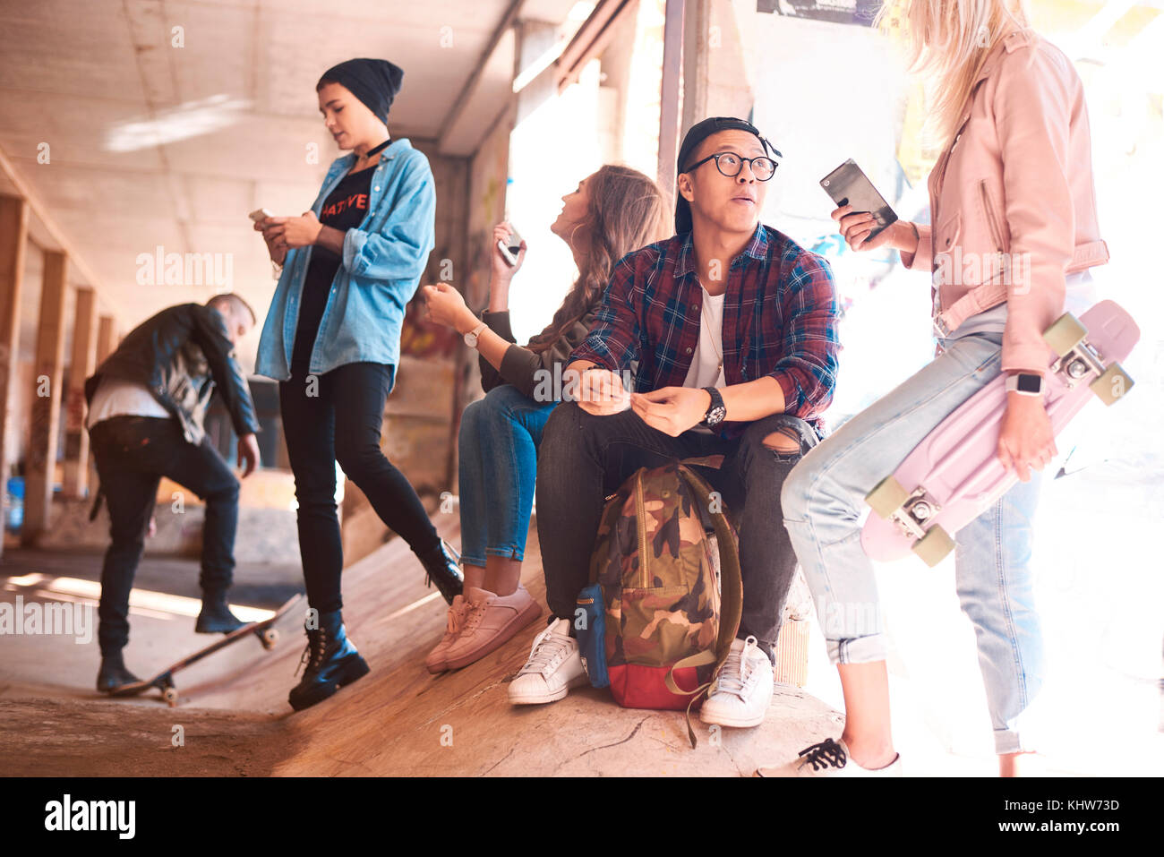 Young skateboarding friends together at skateboard park Stock Photo - Alamy