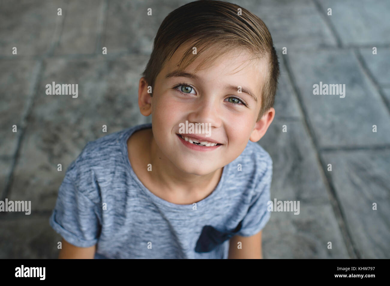 Boy looking up at camera Stock Photo - Alamy