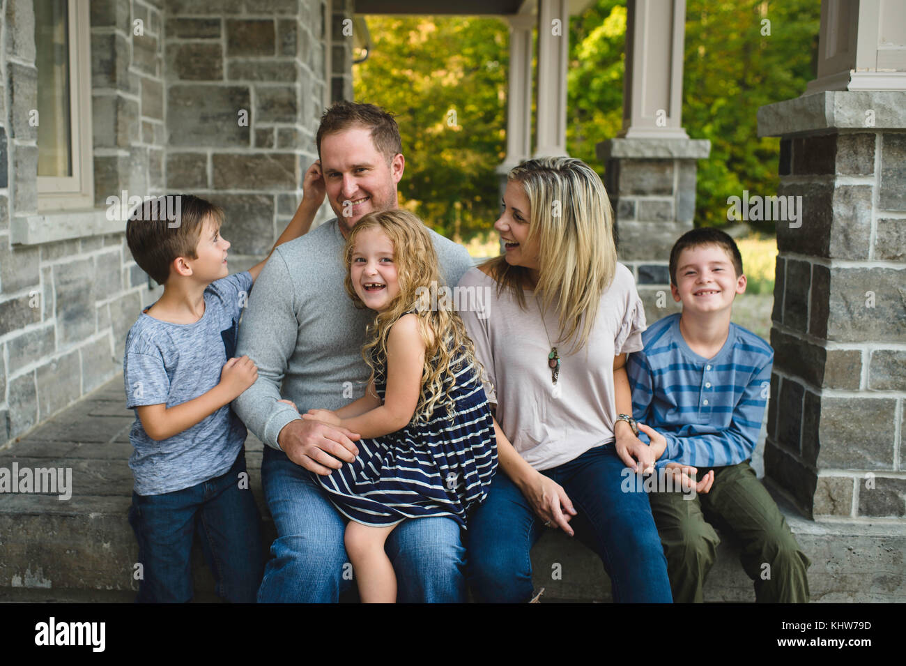 Family on front porch hi-res stock photography and images - Alamy