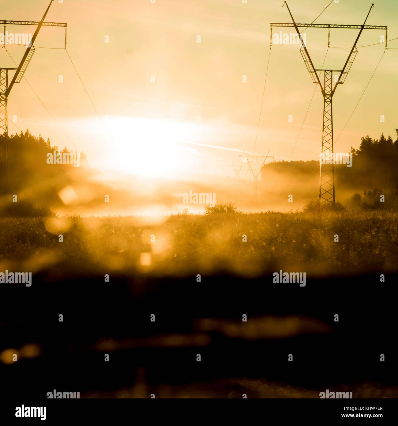 Electrical pylons against sunset Stock Photo - Alamy