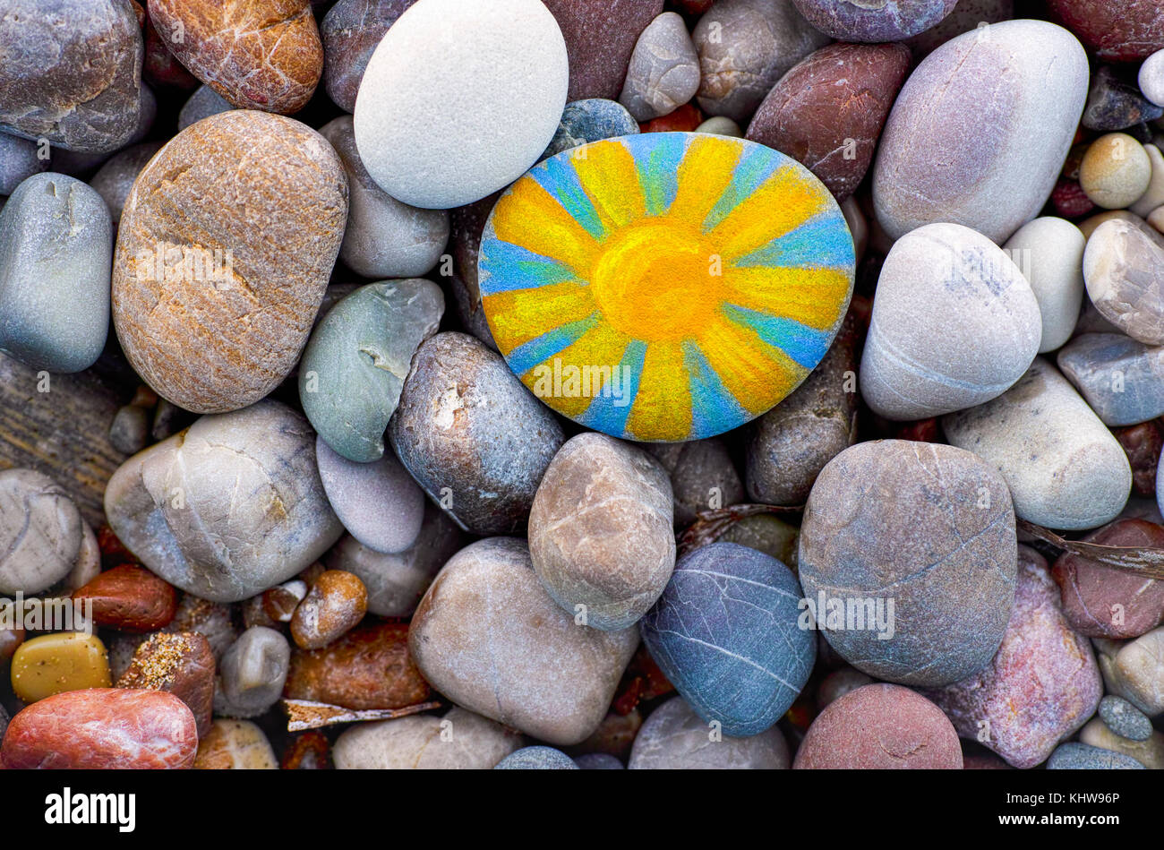 Bright sun painted on pebble. Pebbles background Stock Photo - Alamy