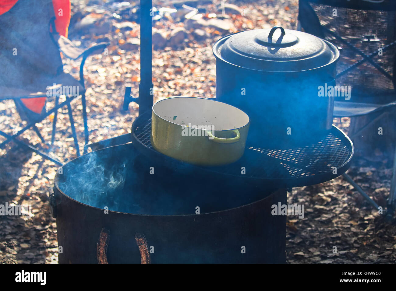 Two pots sitting on grill over a campfire Stock Photo - Alamy