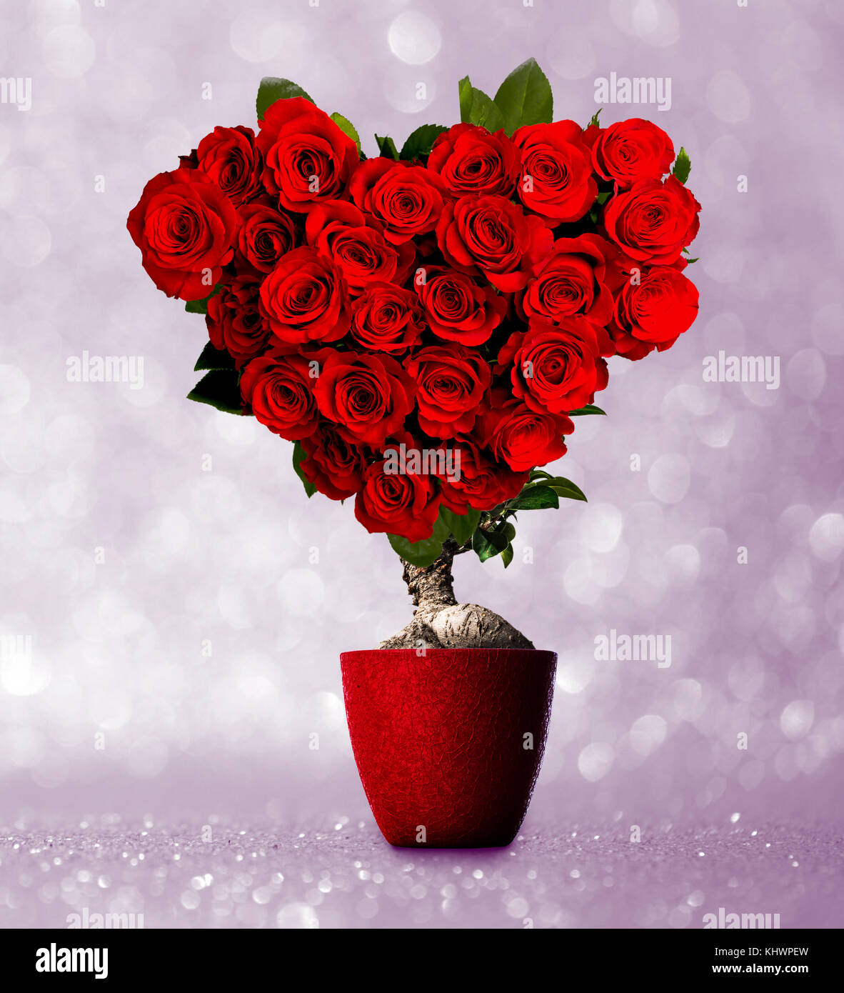 Heart shaped red roses on tree on pink glitter background Stock Photo ...