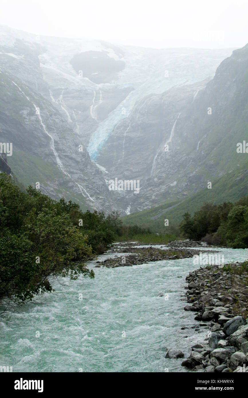 The front lip of Jostedal glacier wind fown through a mountain valley ...