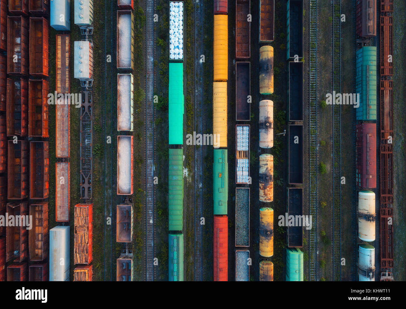 Top view of colorful cargo trains. Aerial view from flying drone of ...