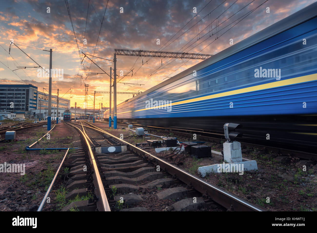 High speed passenger train in motion on railroad track at sunset ...