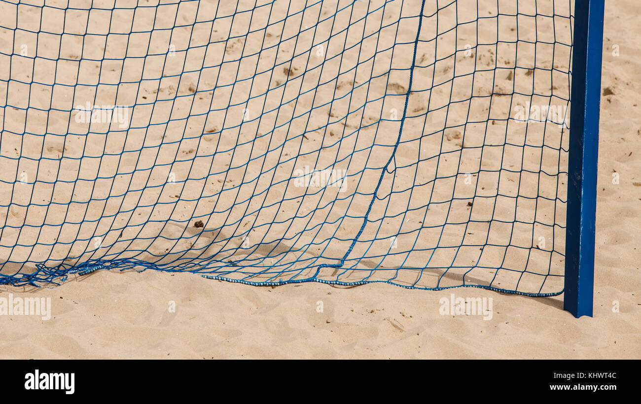 Football summer sport. closeup goal net on a sandy beach outdoor ...