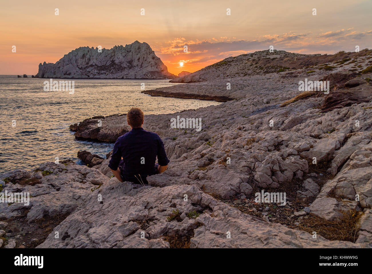 Sun disappearing between two mountains in Les Goudes Stock Photo - Alamy