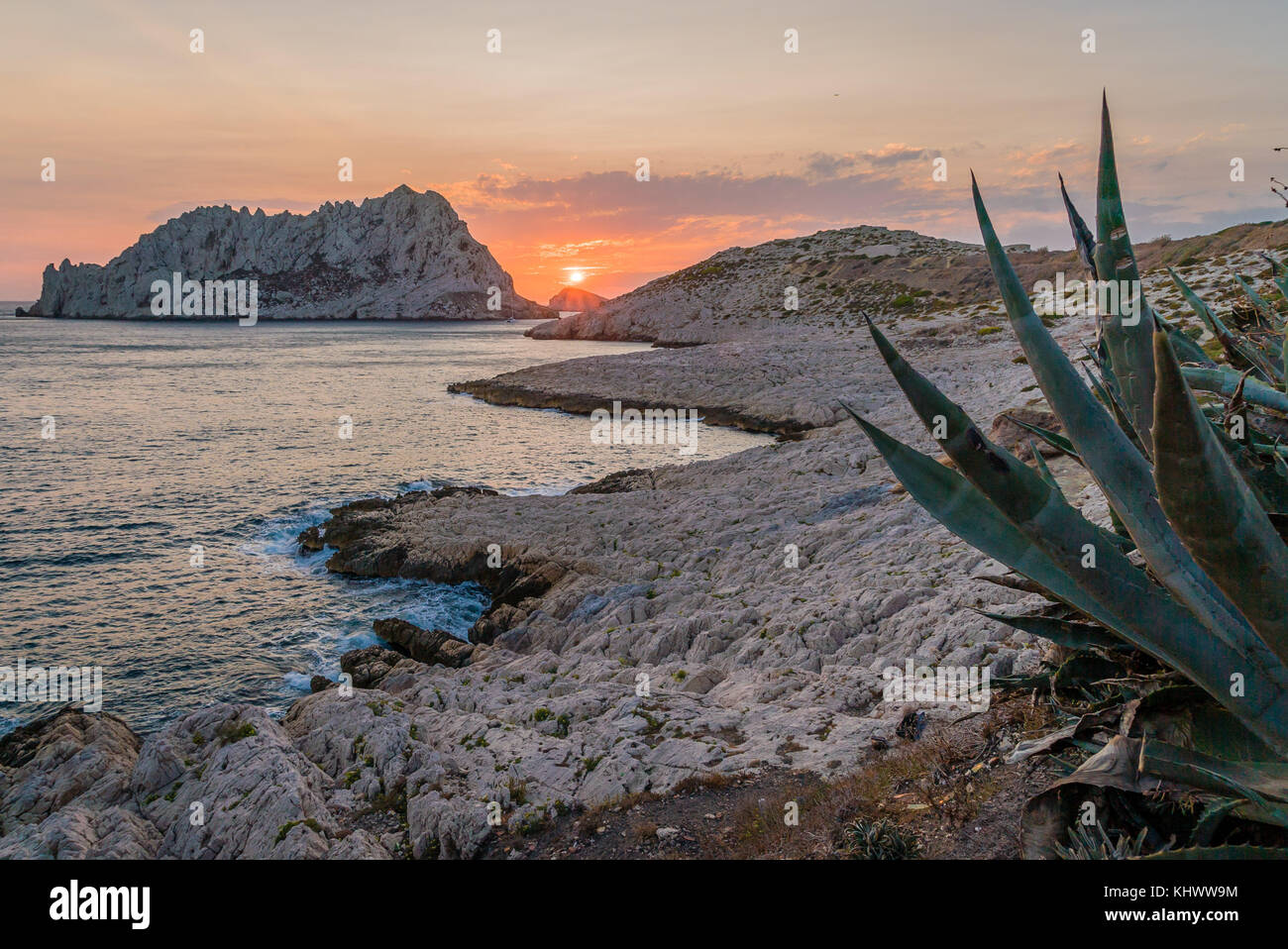 Sun disappearing between two mountains in Les Goudes Stock Photo - Alamy