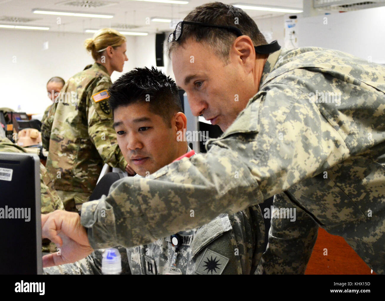 U.S. Army Maj. Moses Scheinfeld (RT) discusses operations with U.S ...