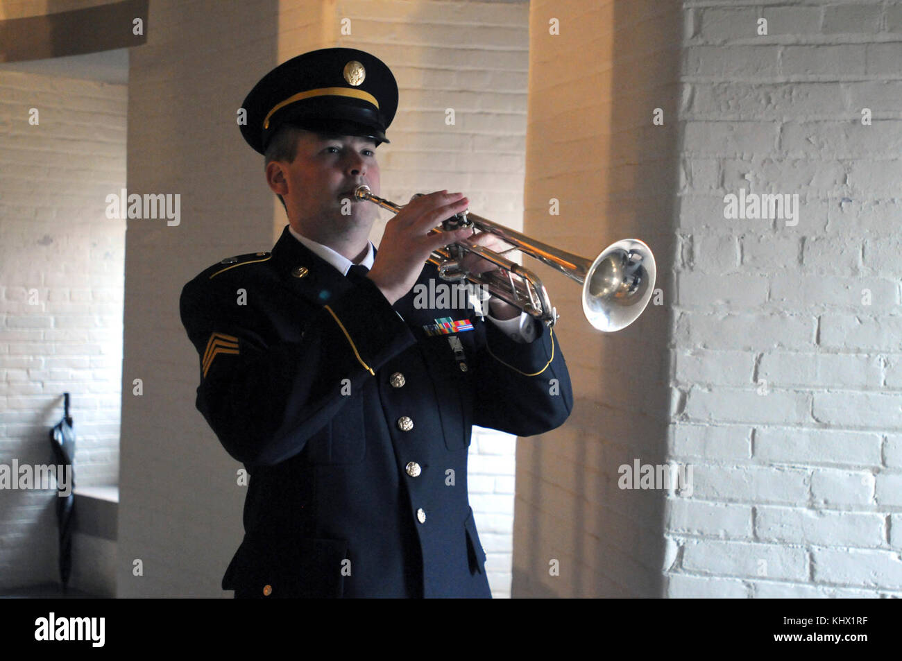 Sergeant Luke Washburn, a bugler with the 338th Army Band, plays Taps ...