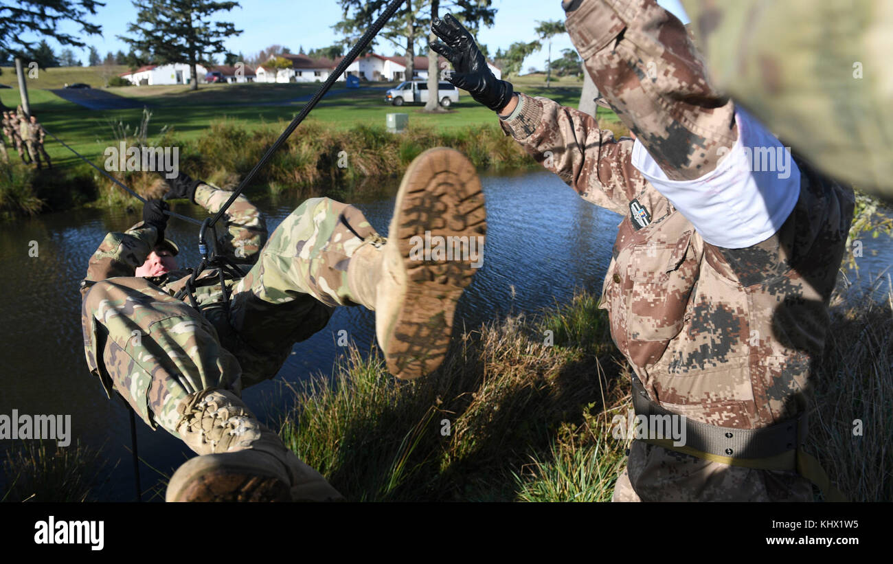 Participants use a one-rope bridge during the 2017 U.S. – China ...