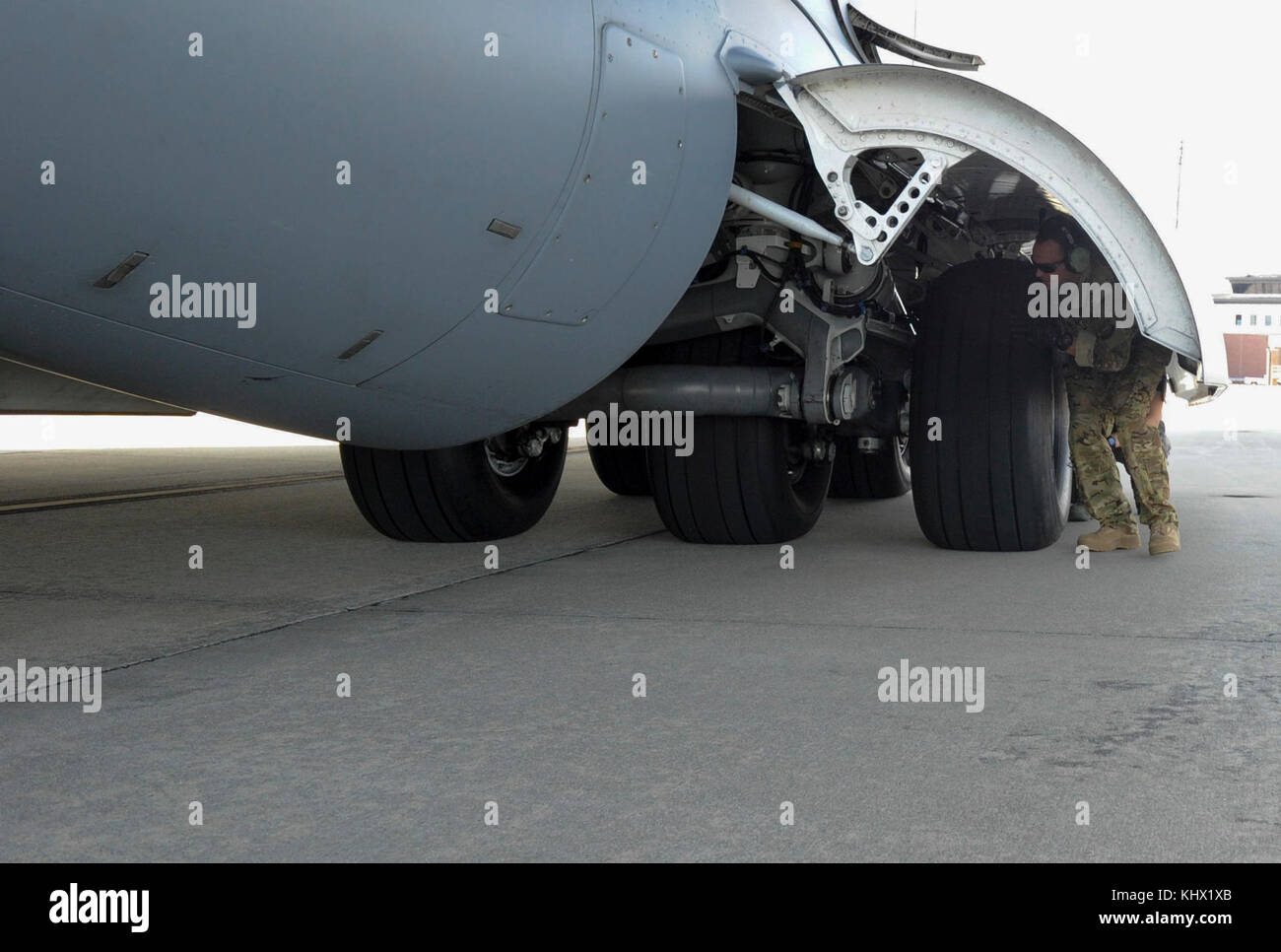 Maj. Benjamin Buxton, 16th Airlift Squadron pilot, inspects the tires ...