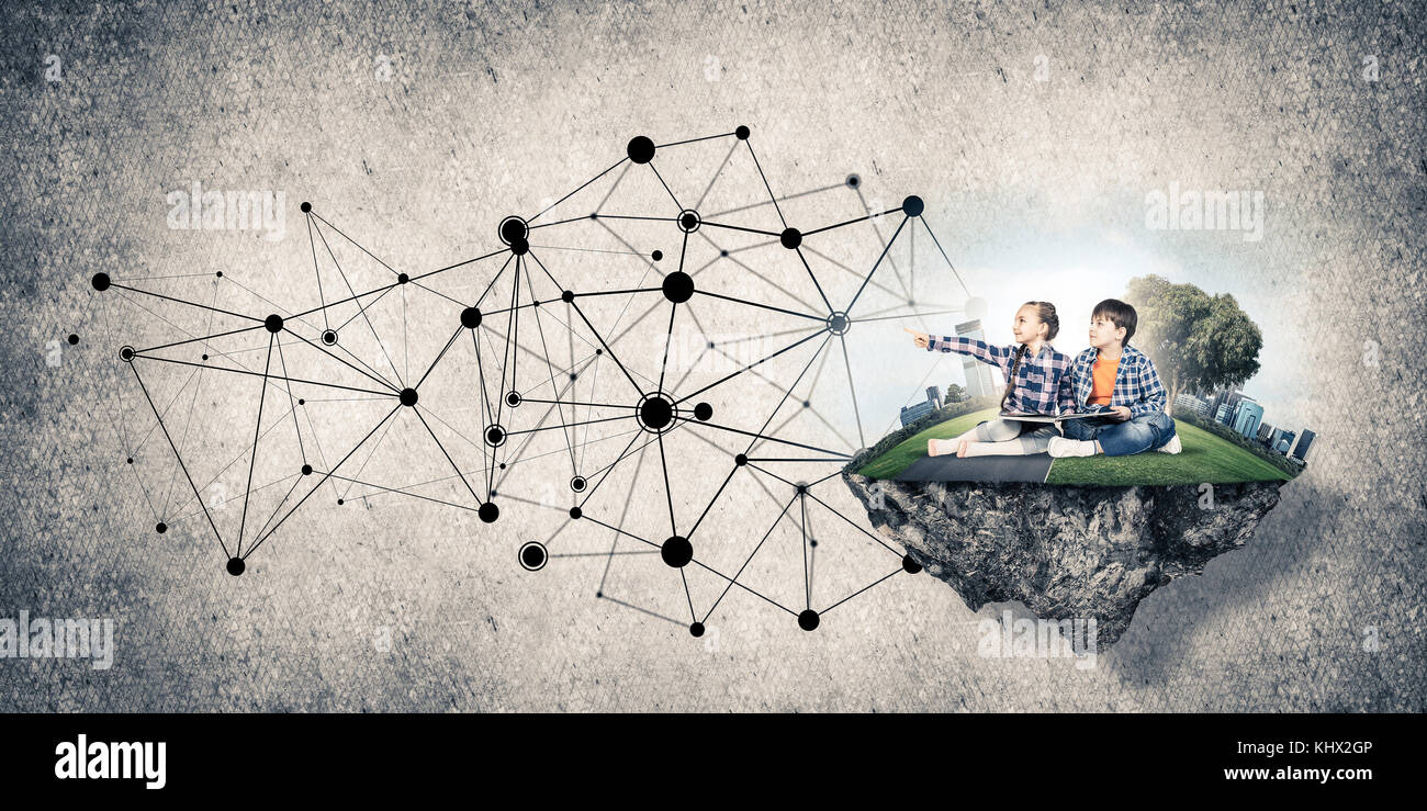 Two kids of school age with book exploring this great world Stock Photo ...