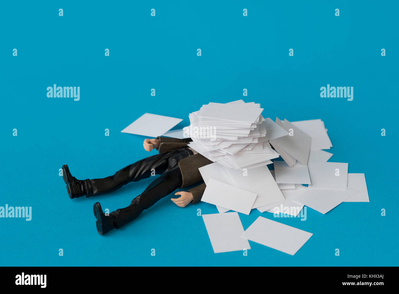 concept of a person swamped with paperwork, blue background Stock Photo ...