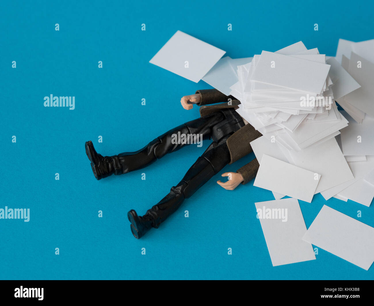 concept of a person swamped with paperwork, blue background Stock Photo ...