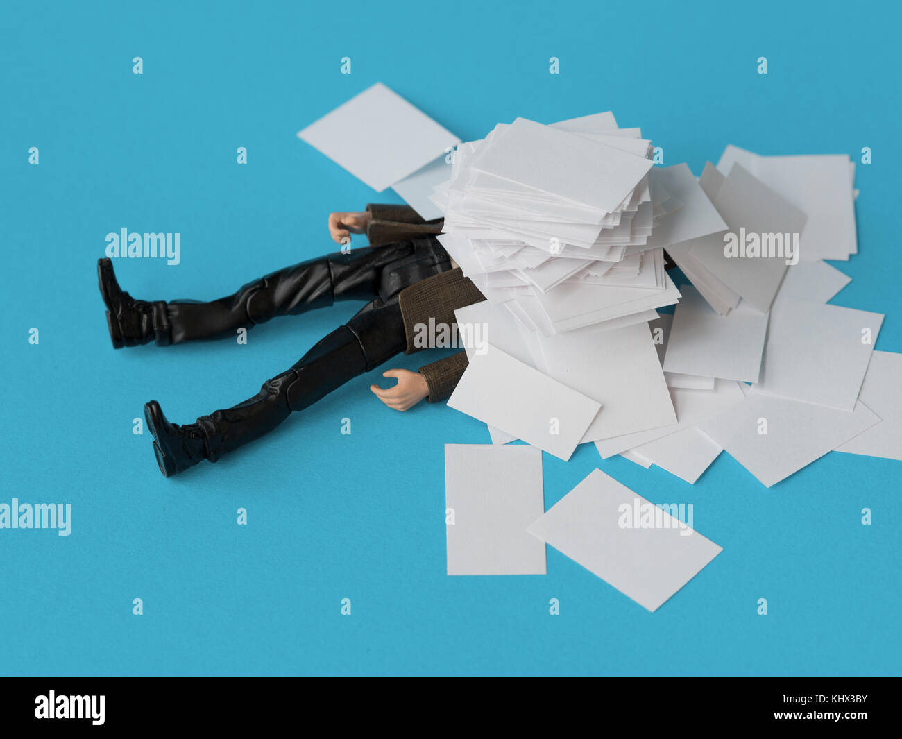 concept of a person swamped with paperwork, blue background Stock Photo ...