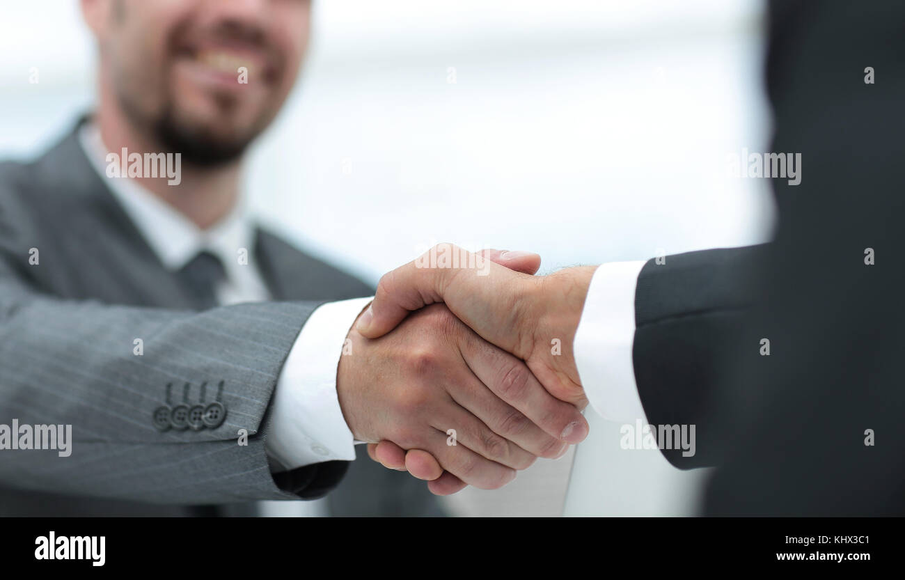 closeup .handshake of business partners on a Desk Stock Photo - Alamy