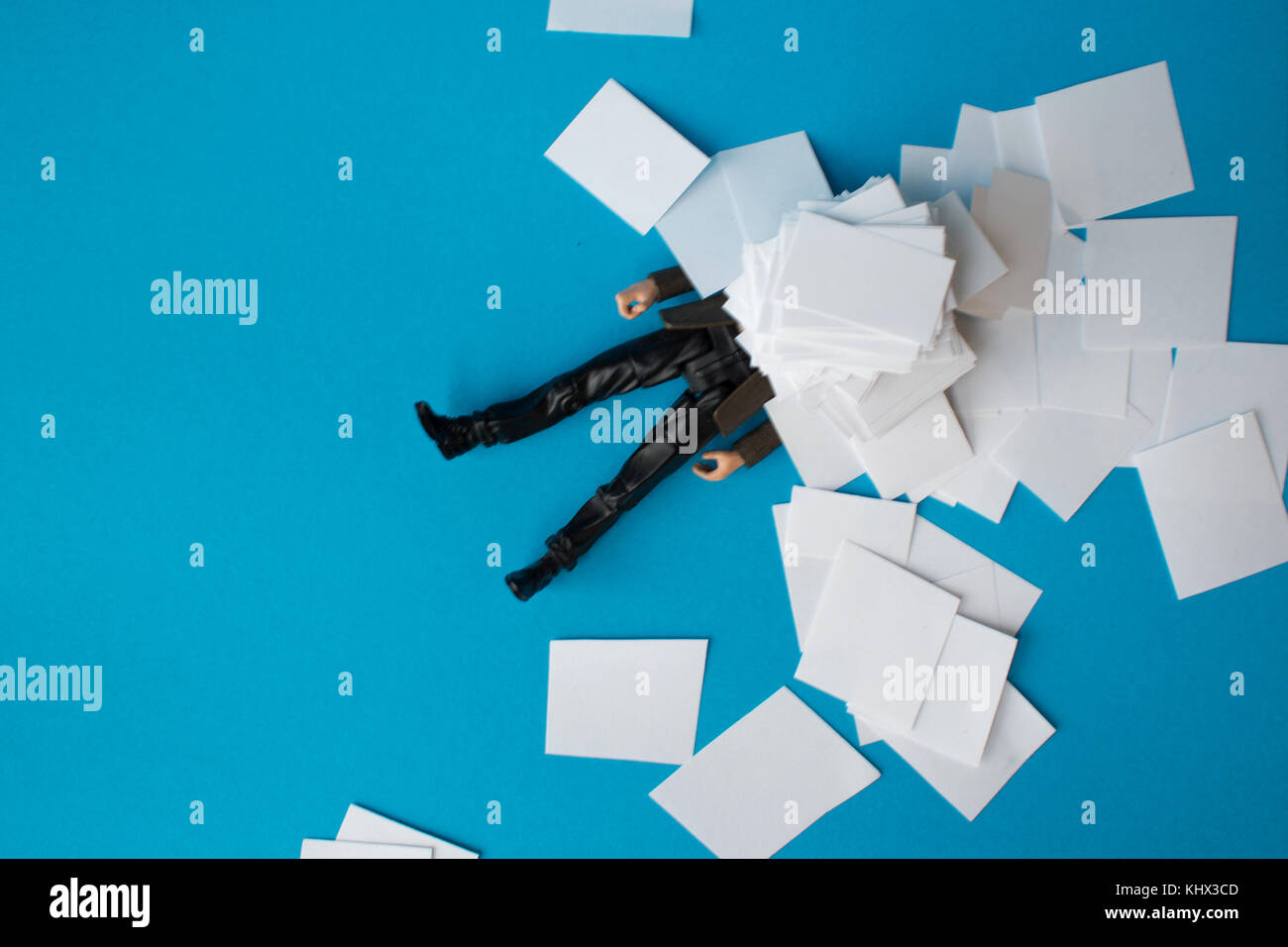 concept of a person swamped with paperwork, blue background Stock Photo ...